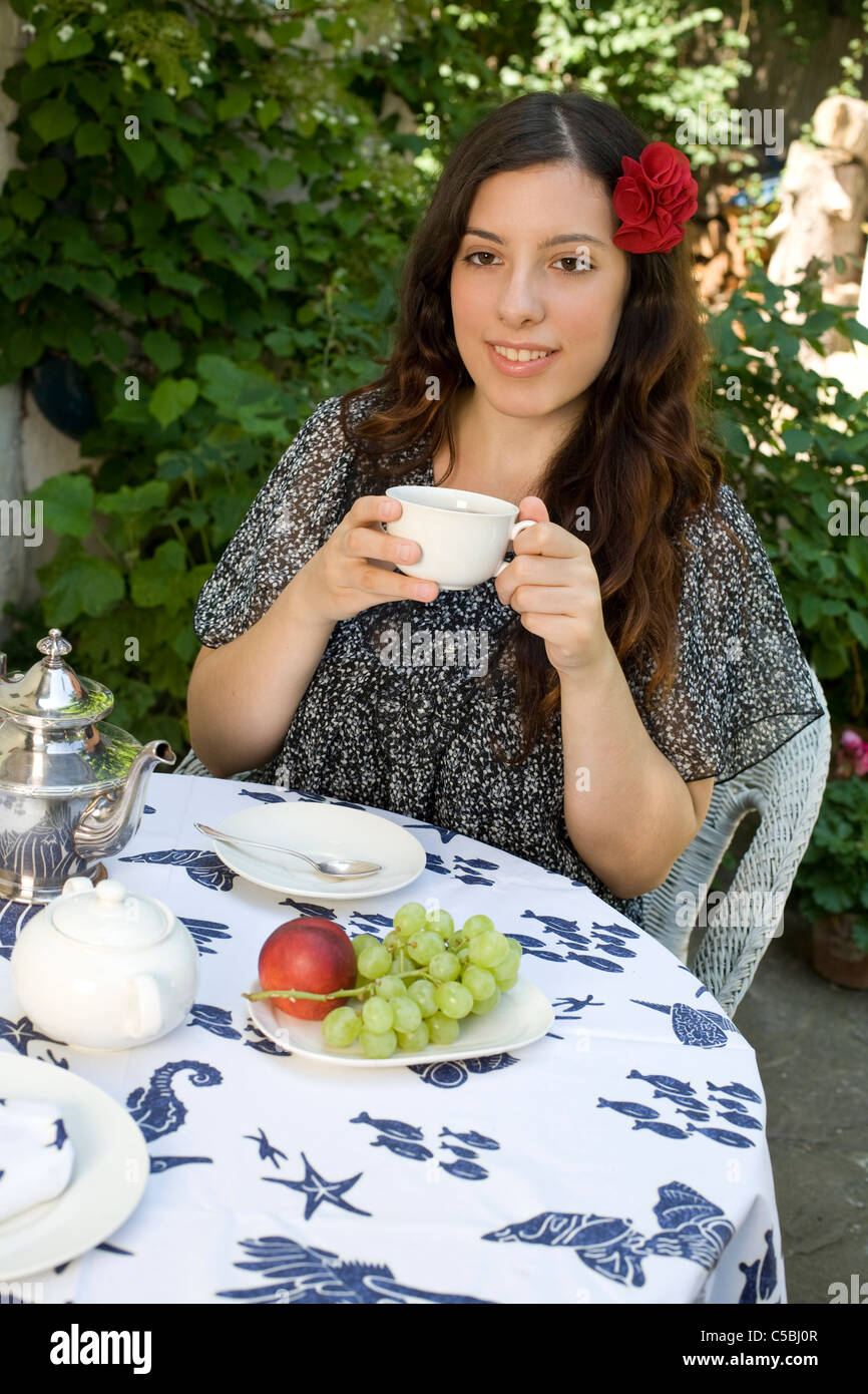 young woman drinking tea in the garden Stock Photo - Alamy