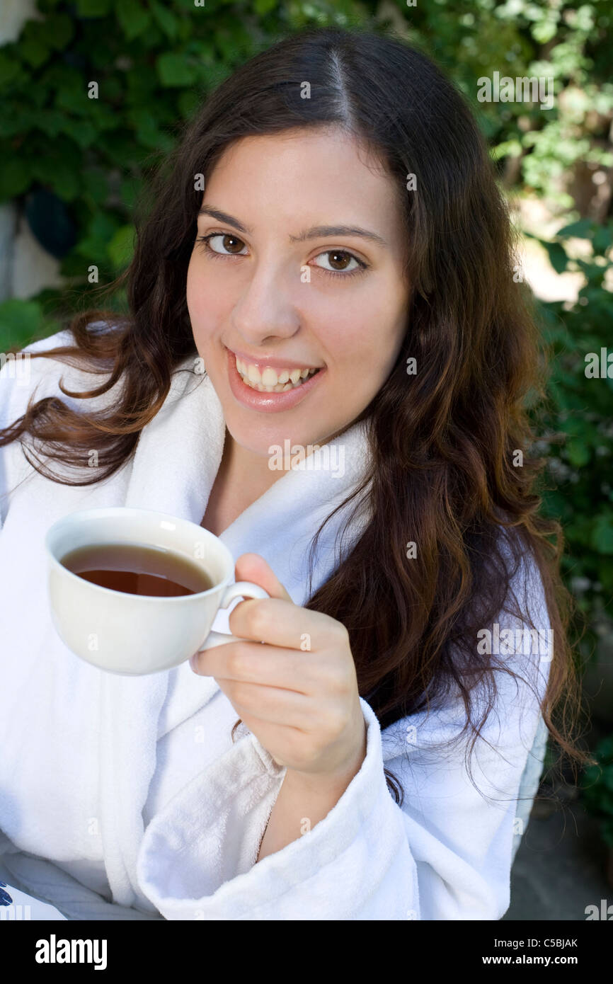 young woman drinking tea in the garden Stock Photo - Alamy