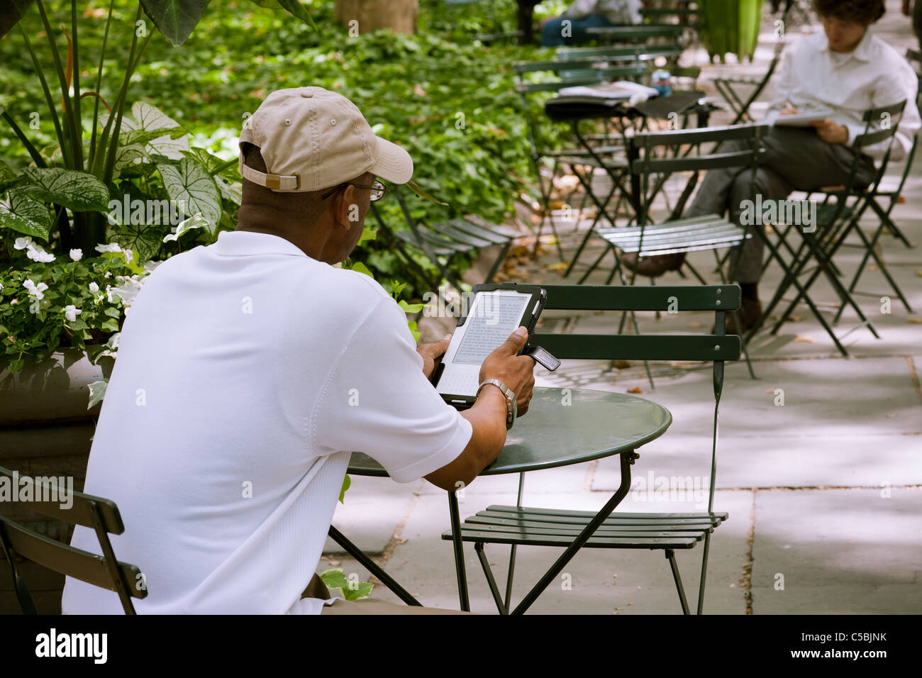 A reader uses his Amazon Kindle ereader in Bryant Park in New York on ...