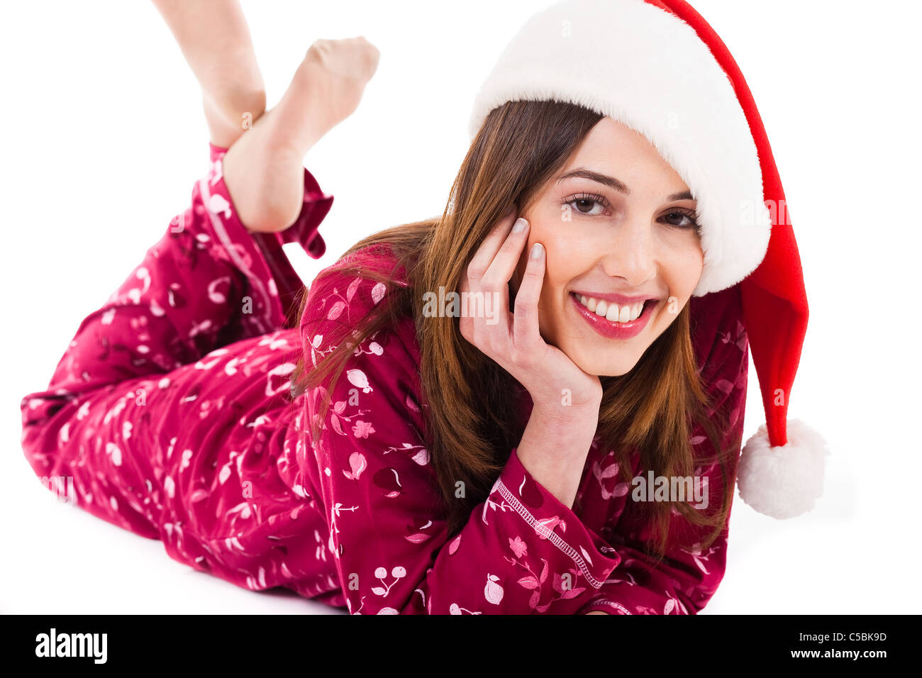 Santa girl relaxing by lying down and smiling on a light background ...