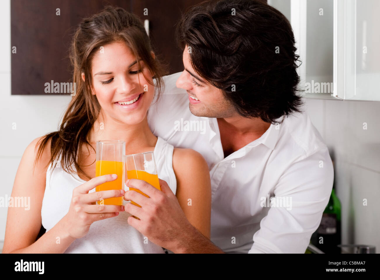young couple making cheers and enjoying juice Stock Photo - Alamy