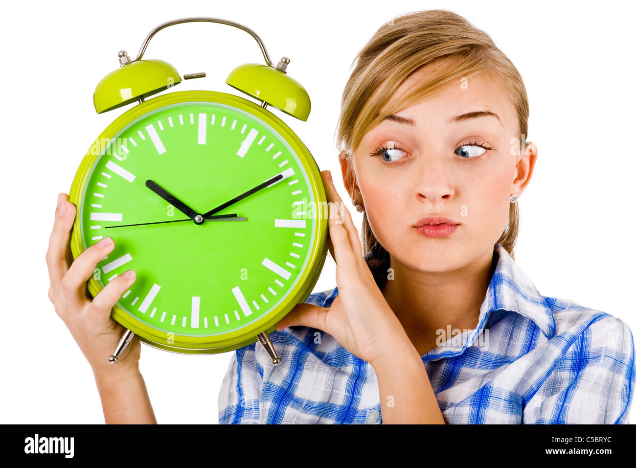 Girl giving funny expression and holding the alarm on a isolated white ...