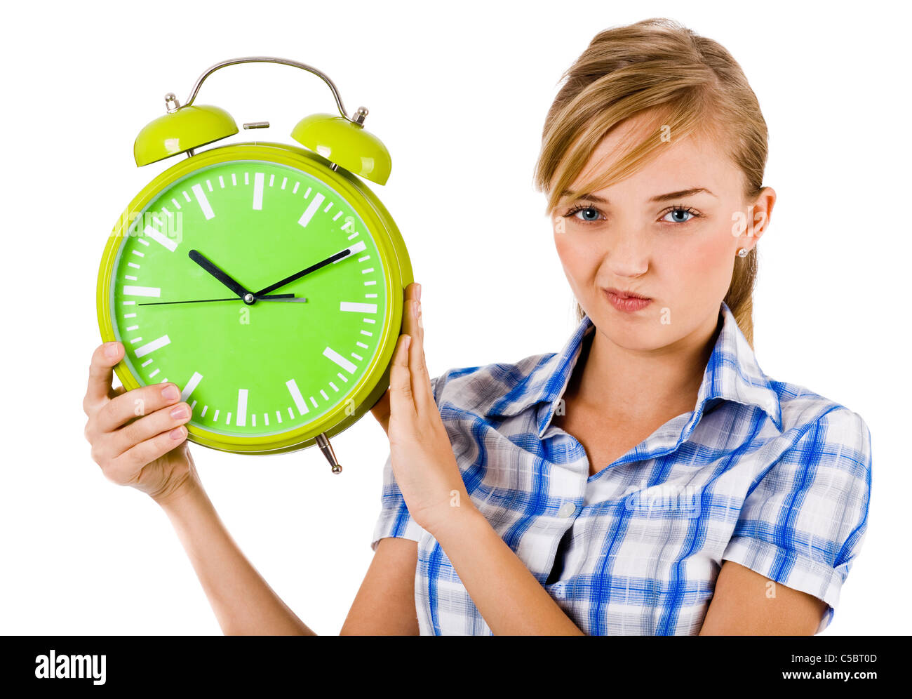 Girl giving funny expression and holding the alarm on a isolated white ...