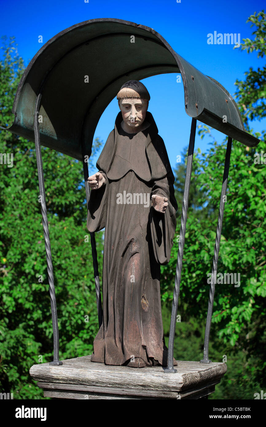monk figure at water pump in the glentleiten open air museum. upper ...