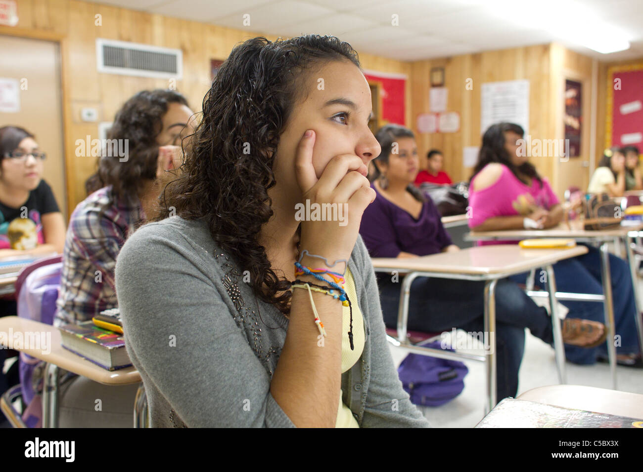 Hispanic female student listens and pays attention in her South Texas ...