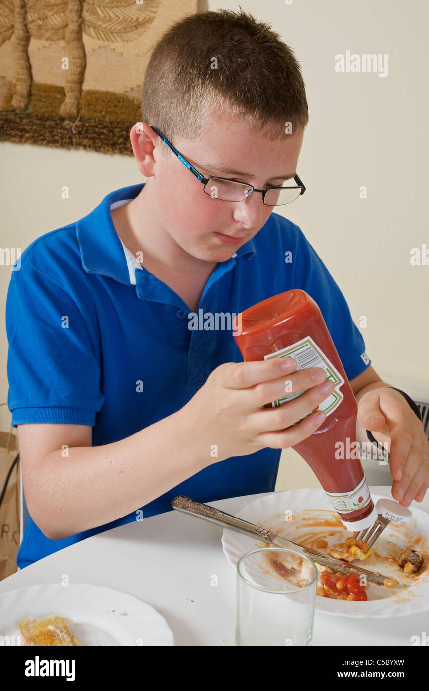 Teenage boy eating cooked breakfast Stock Photo - Alamy