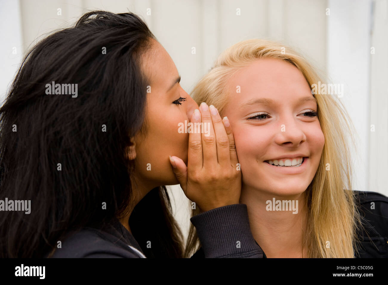 Whispering girls close up hi-res stock photography and images - Alamy