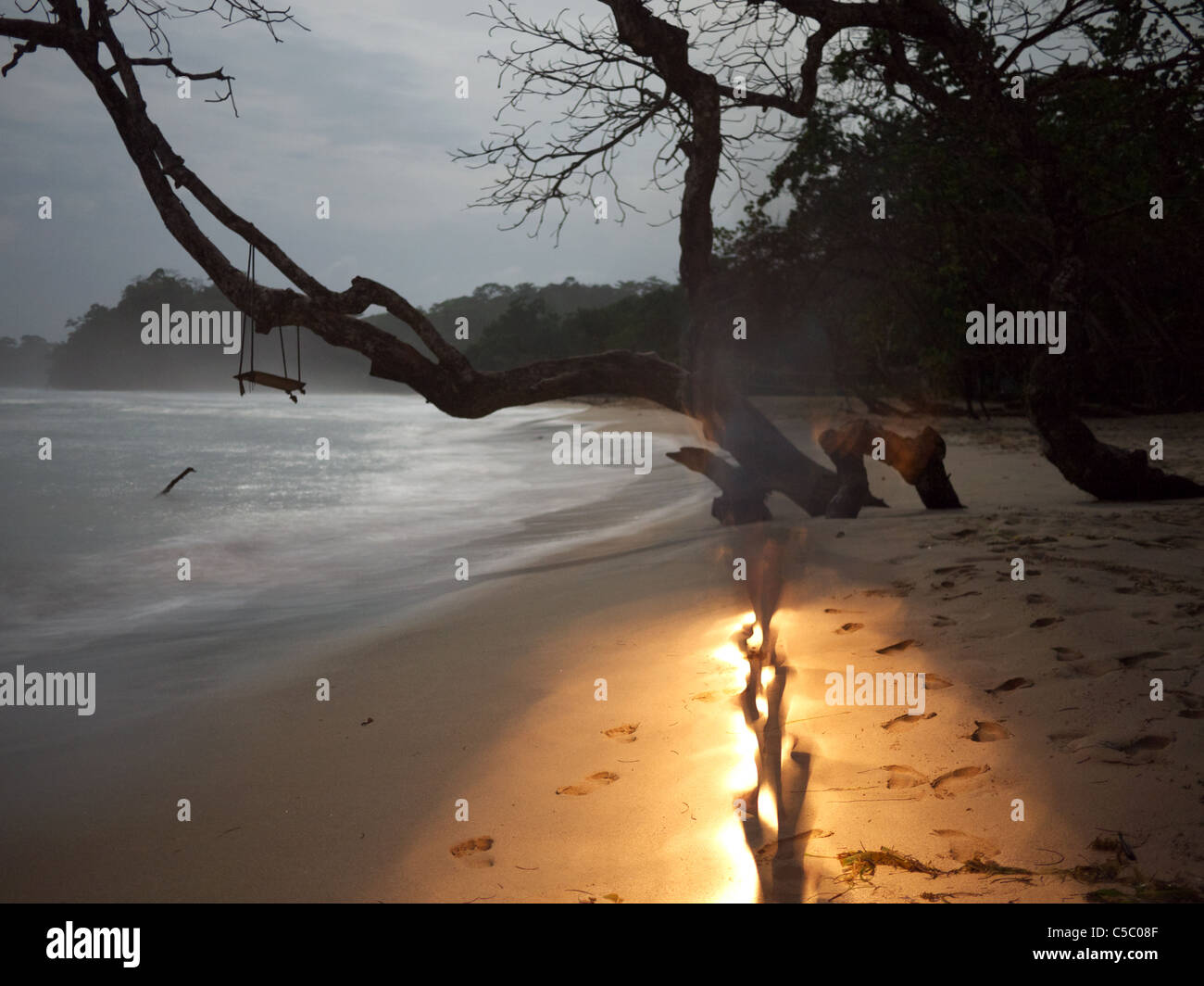 Footsteps at night on beach Stock Photo - Alamy