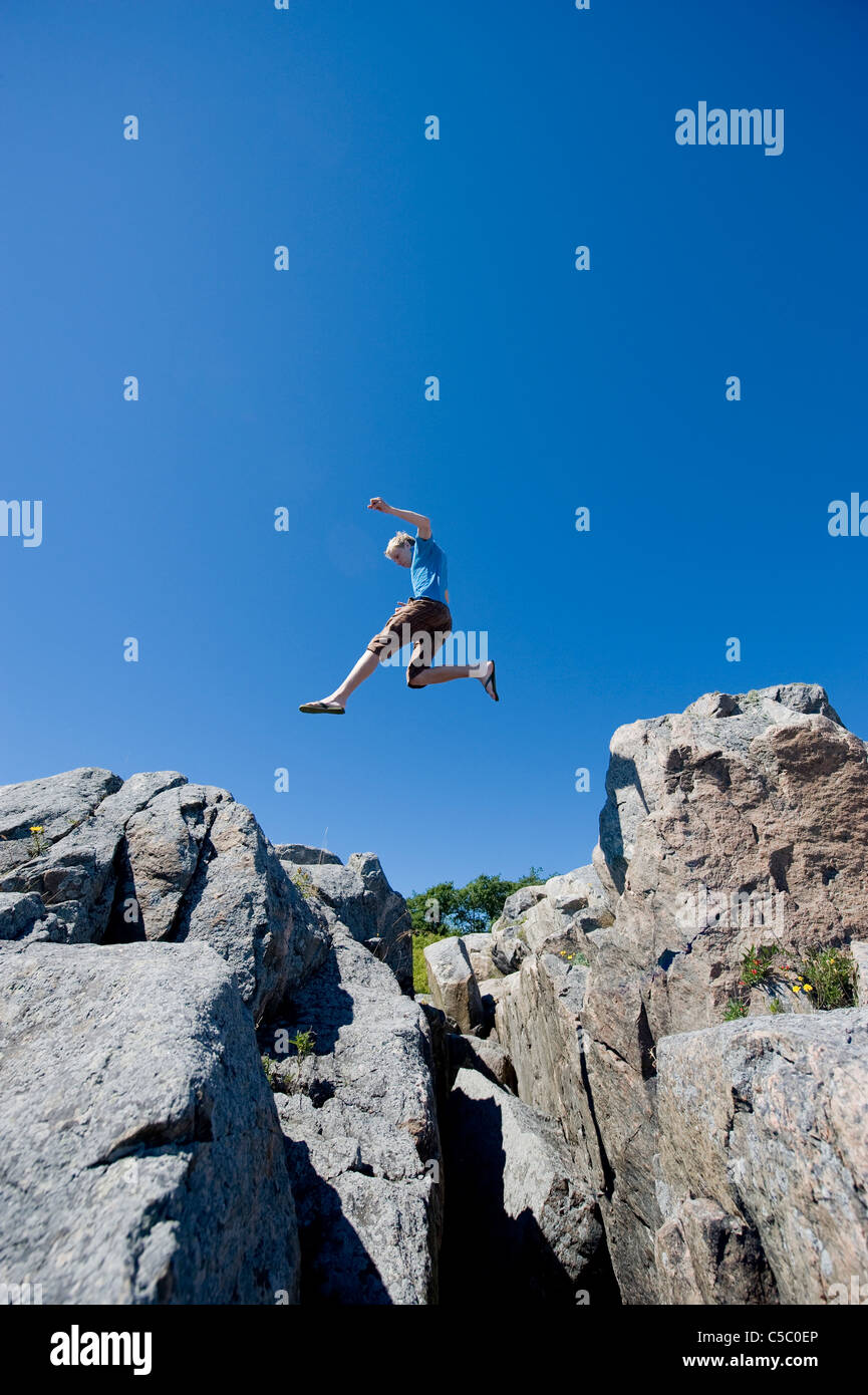 Boy playing with rocks hi-res stock photography and images - Alamy