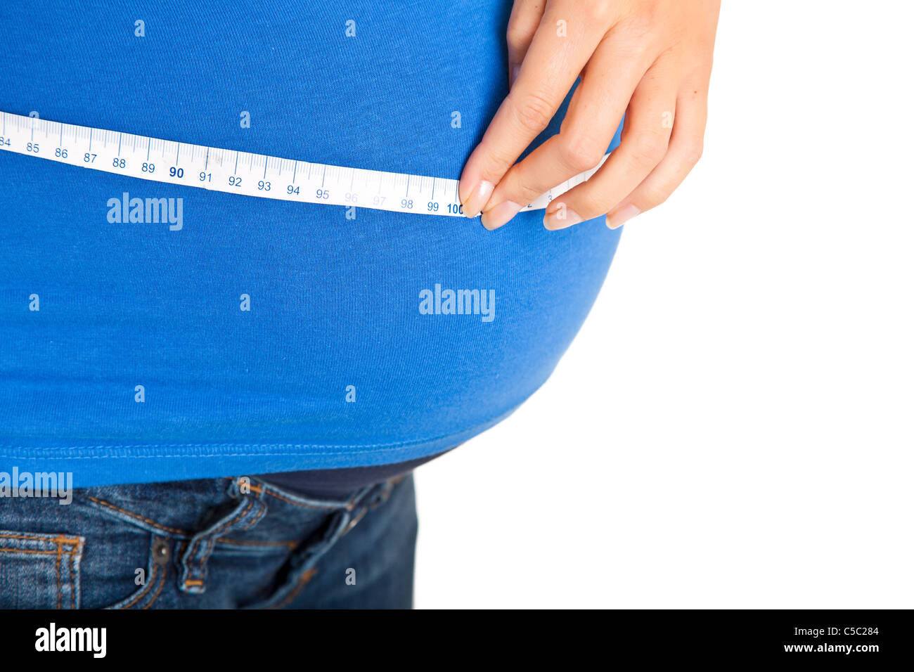 Pregnant woman measuring stomach isolated on white Stock Photo - Alamy