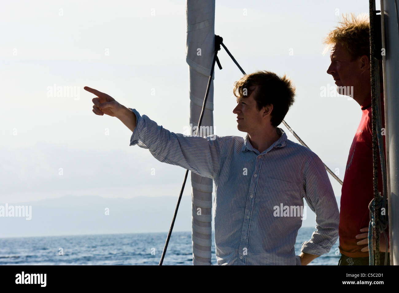 Two pointing men stand hi-res stock photography and images - Alamy