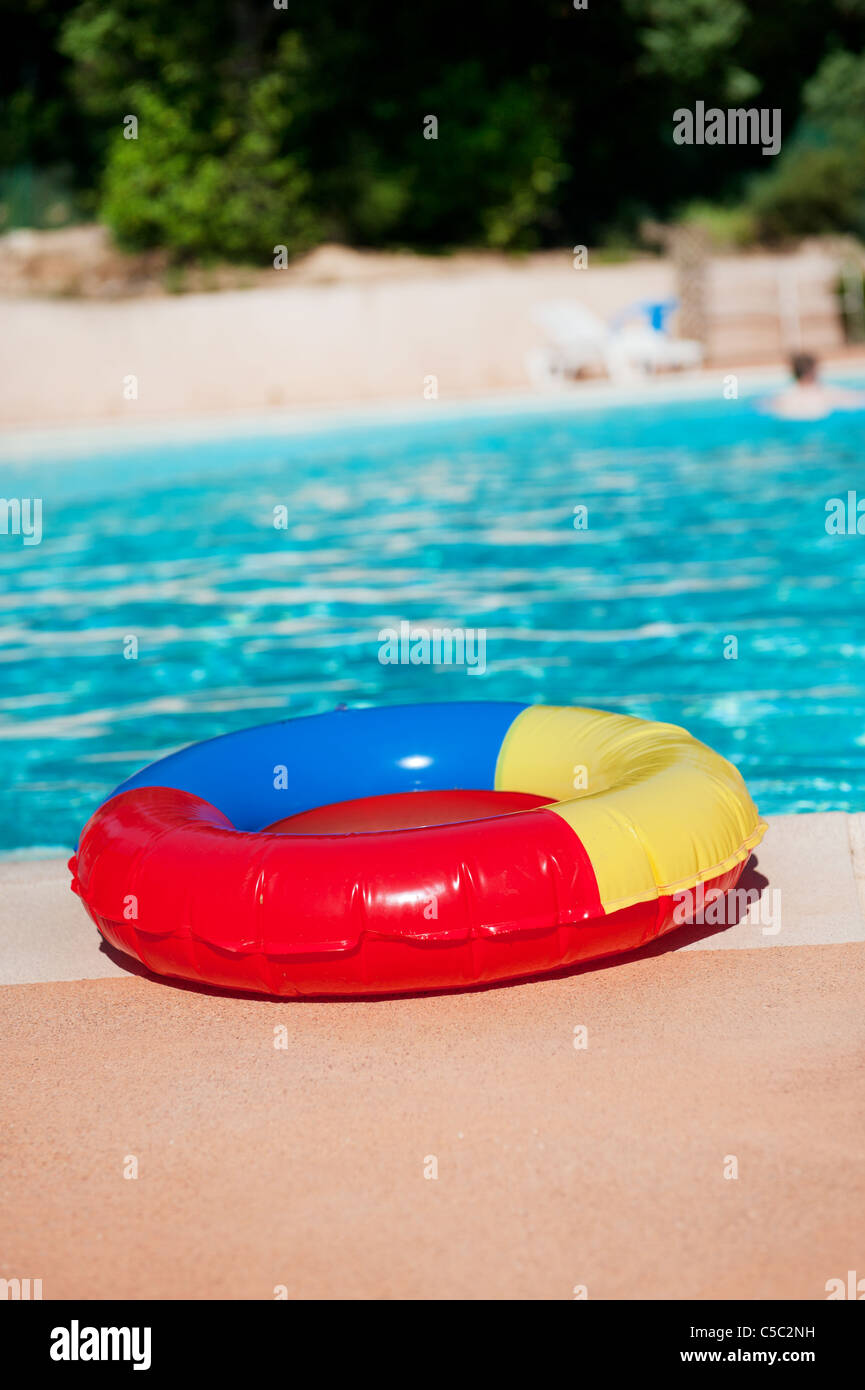 Colorful toy swimming tire at the pool Stock Photo - Alamy