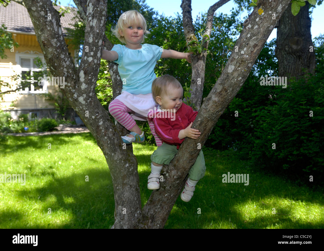 Two Girls Playing By A Tree High Resolution Stock Photography and ...