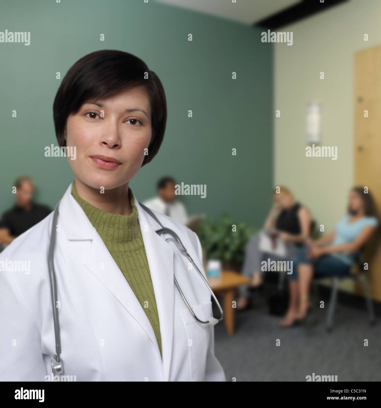 Mixed race doctor standing in waiting room Stock Photo - Alamy