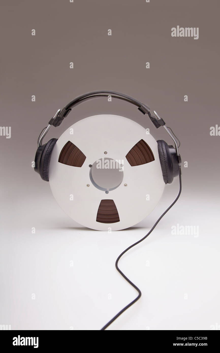 Headphones On A Reel Of Recording Tape Stock Photo - Alamy