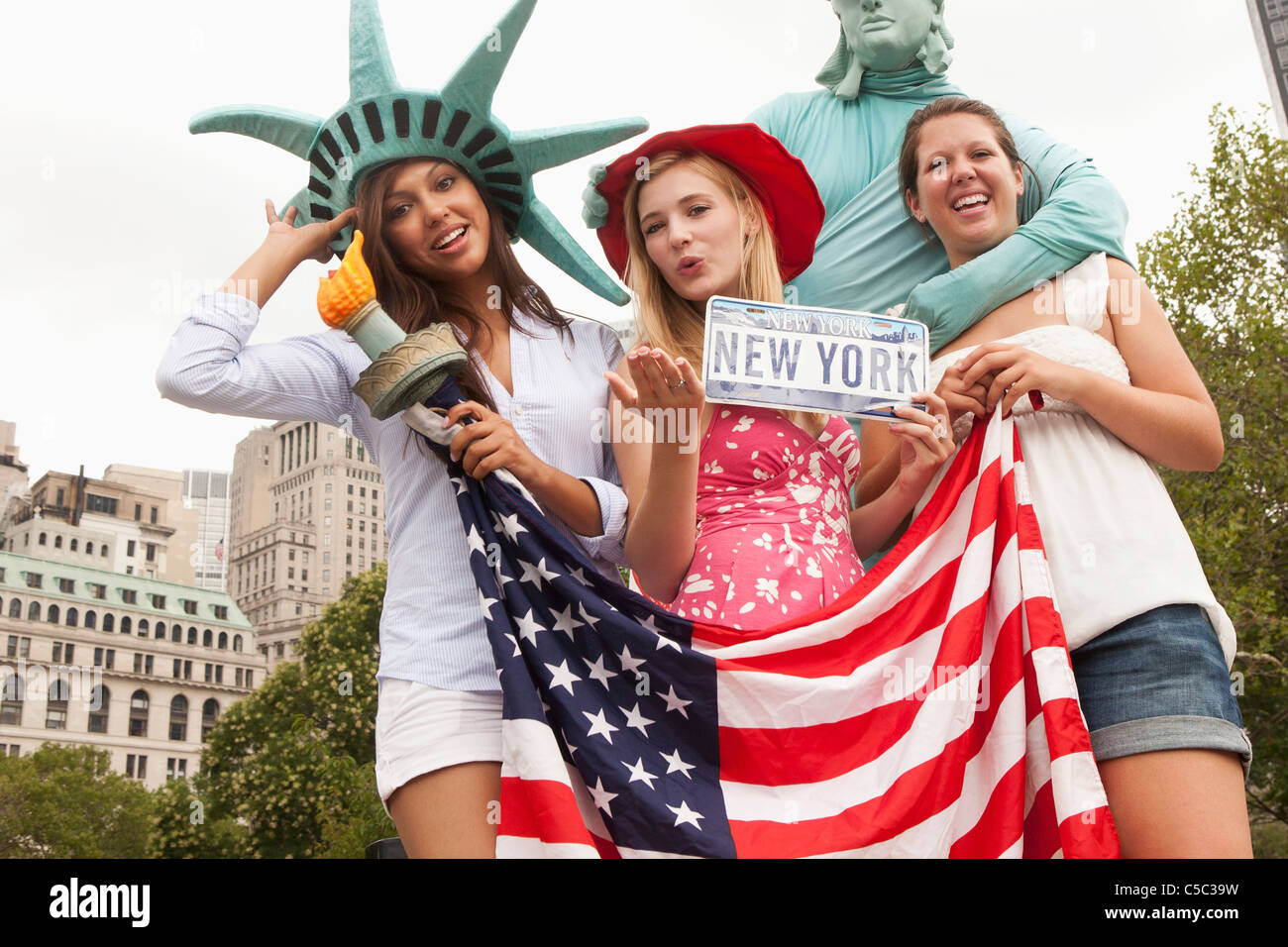 Laughing friends visiting the Statue of Liberty Stock Photo - Alamy