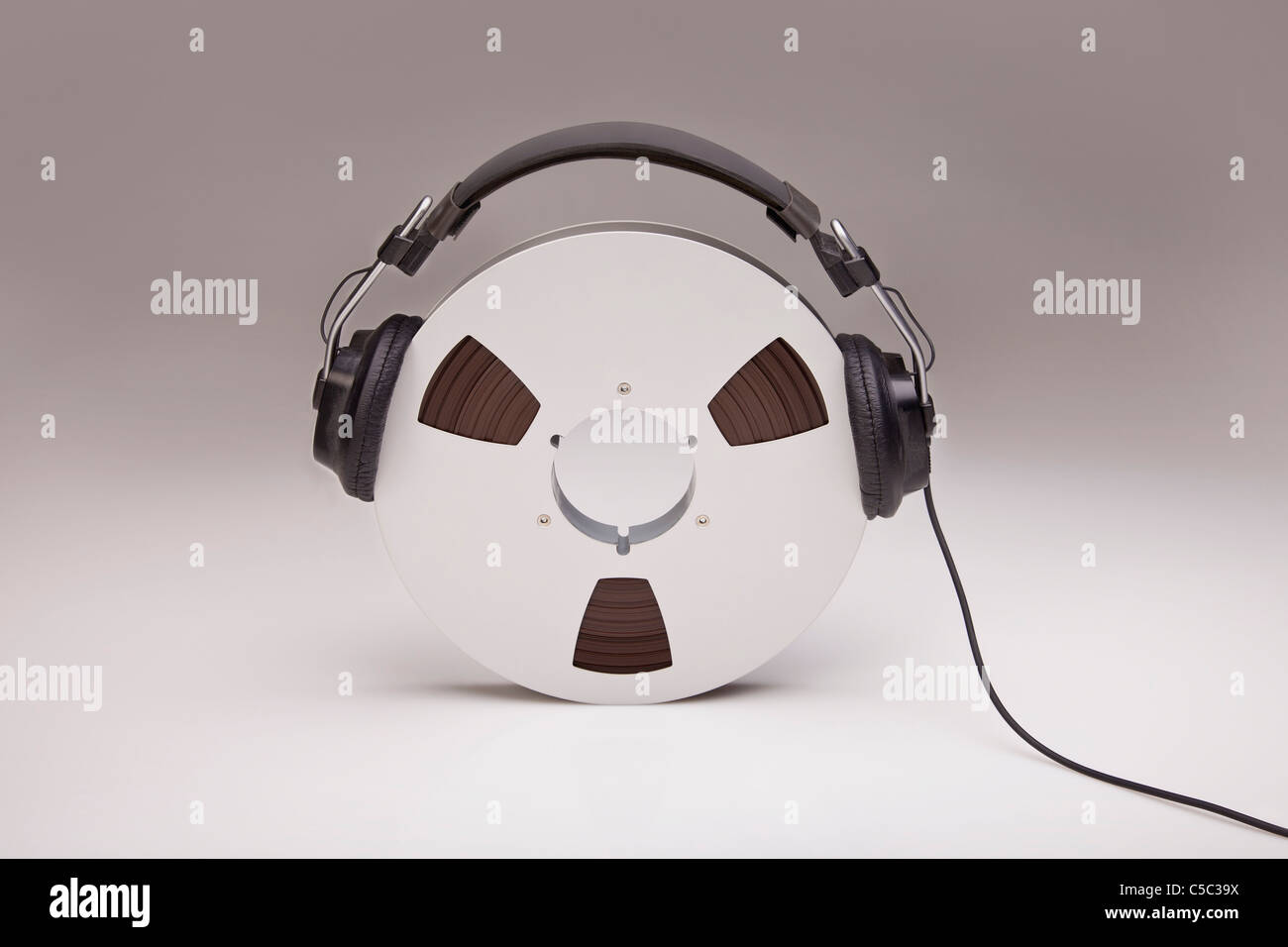Headphones On A Reel Of Recording Tape Stock Photo - Alamy