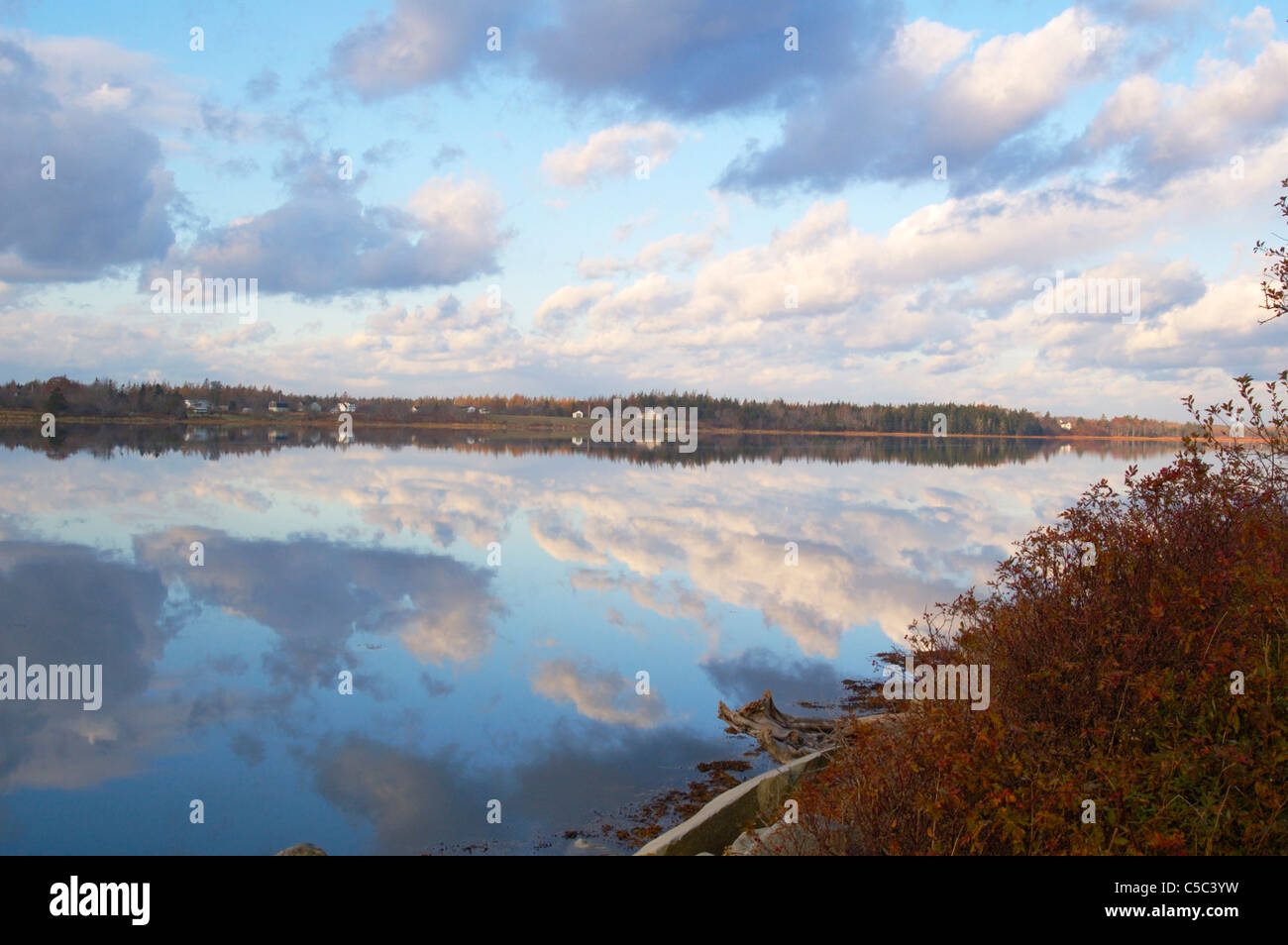 A salt water river on a brisk autumn morning with reflective water ...