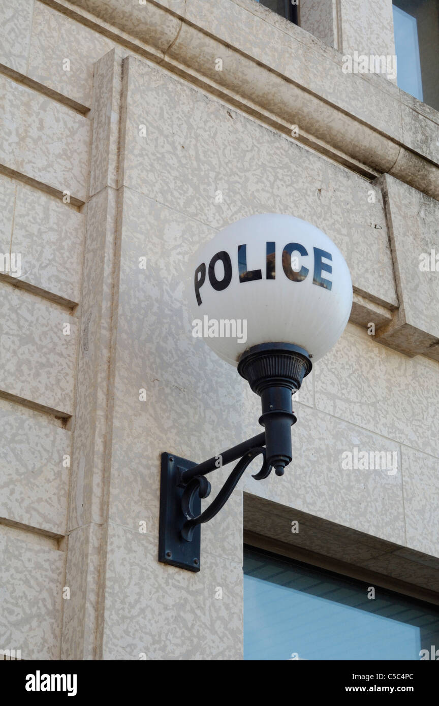 An old lamp outside of a police station doubles as both a lamp and a ...