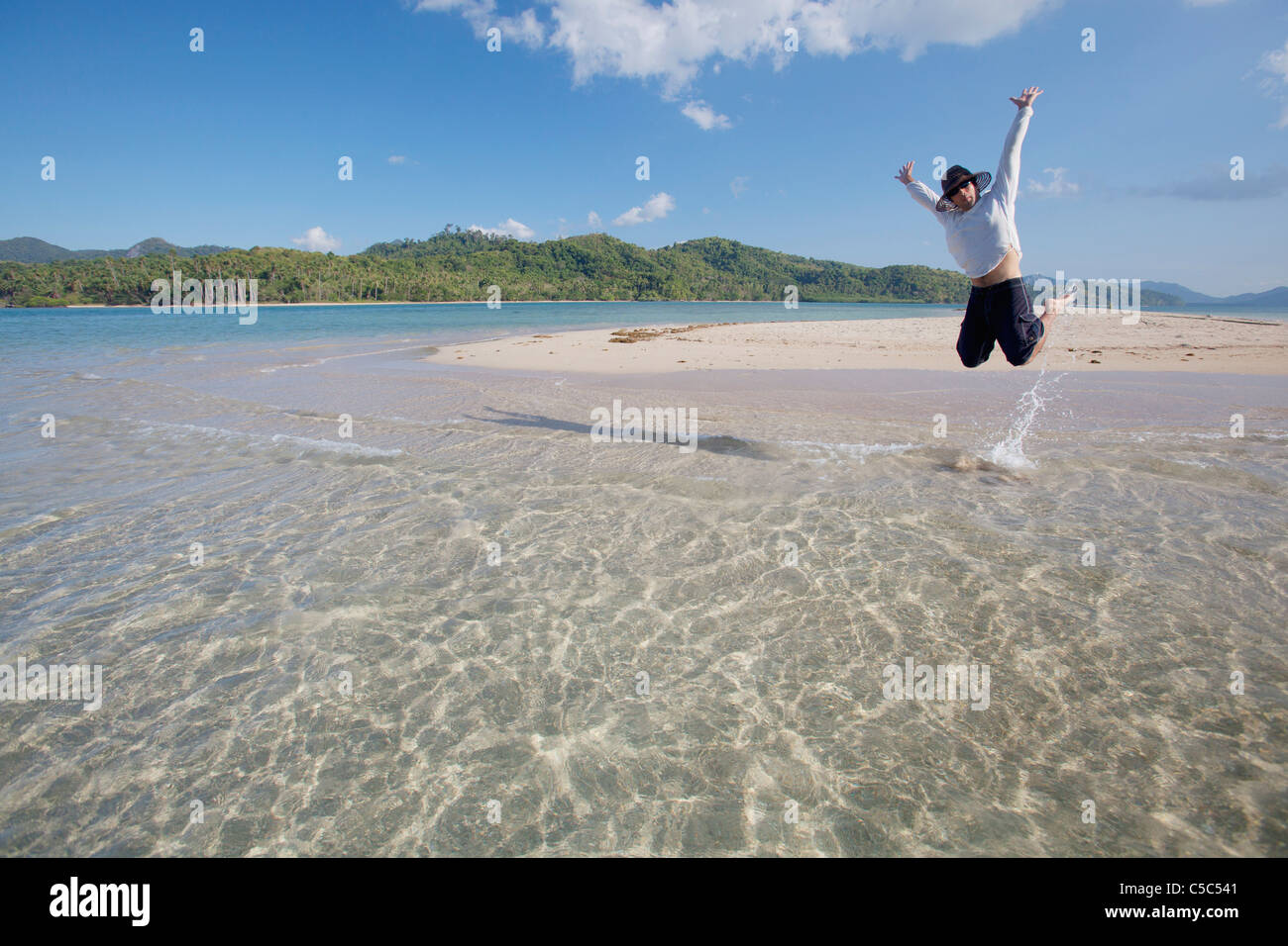 Man Jumping Above The Tropical Water; Bacuit Archipelago, Palawan ...