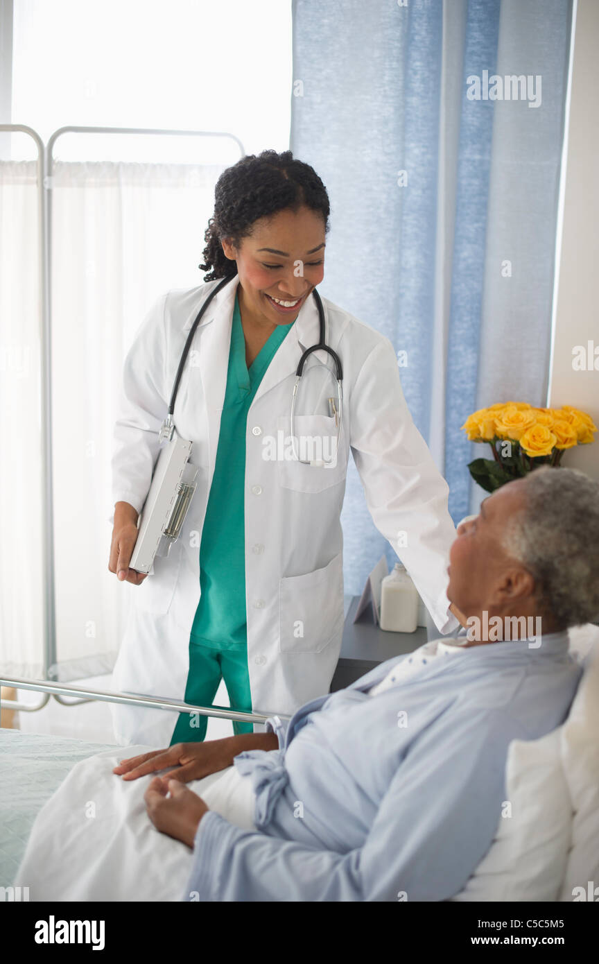 Doctor checking on patient in hospital Stock Photo - Alamy