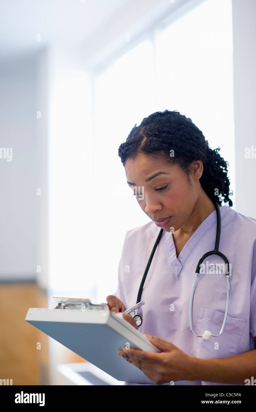 Nurse writing in medical record in hospital Stock Photo - Alamy