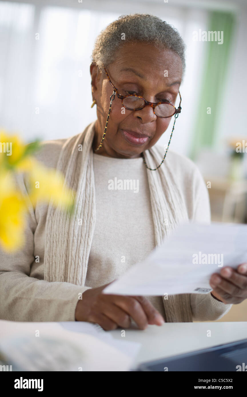 Black woman reading letter Stock Photo - Alamy
