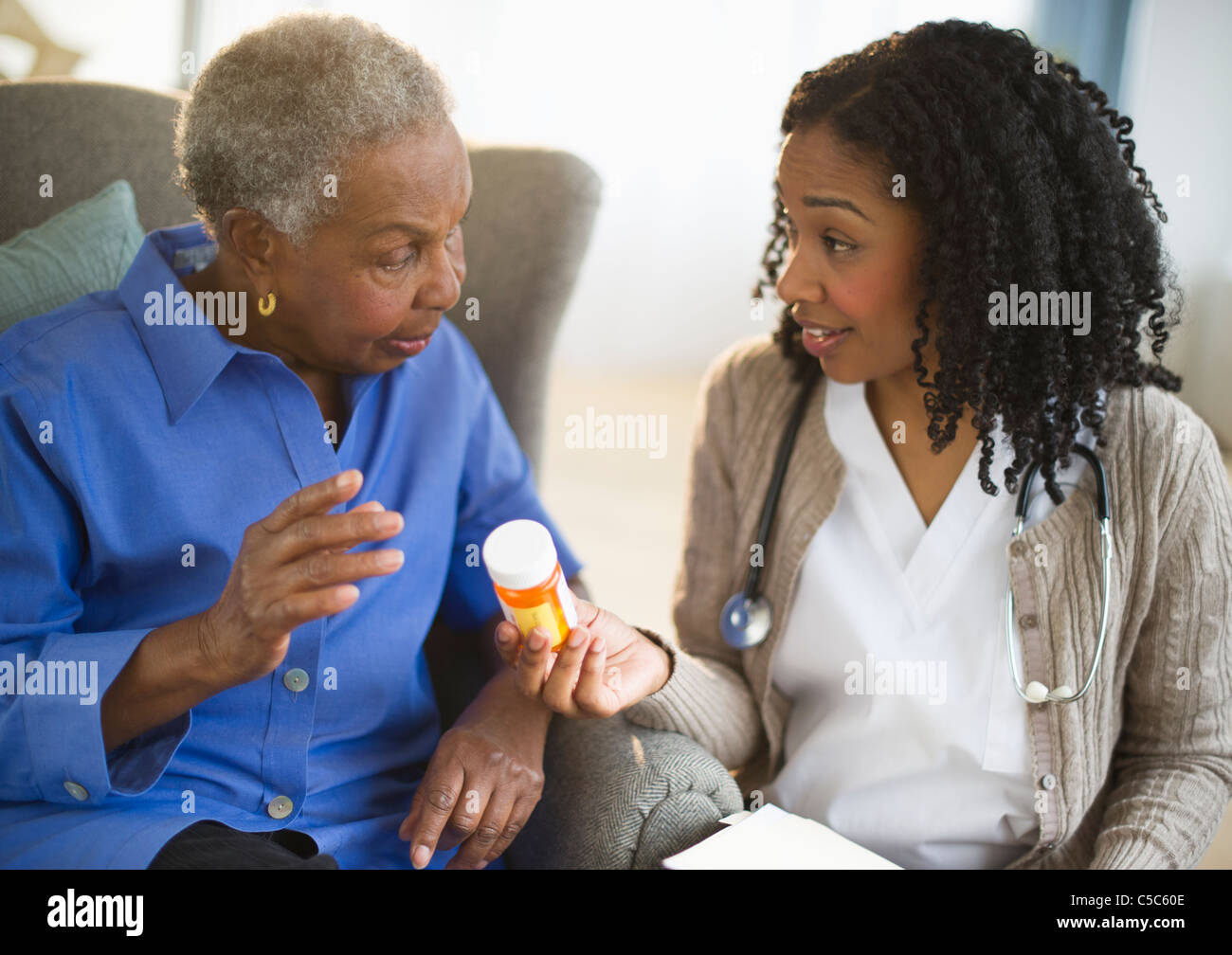 Nurse explaining medication to woman Stock Photo - Alamy