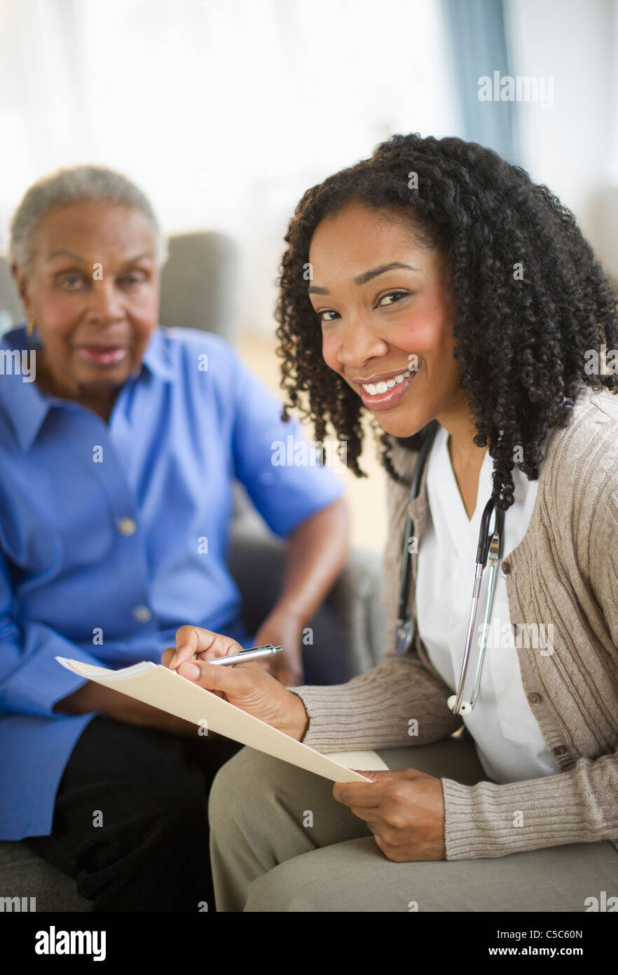 Nurse giving woman checkup hi-res stock photography and images - Alamy