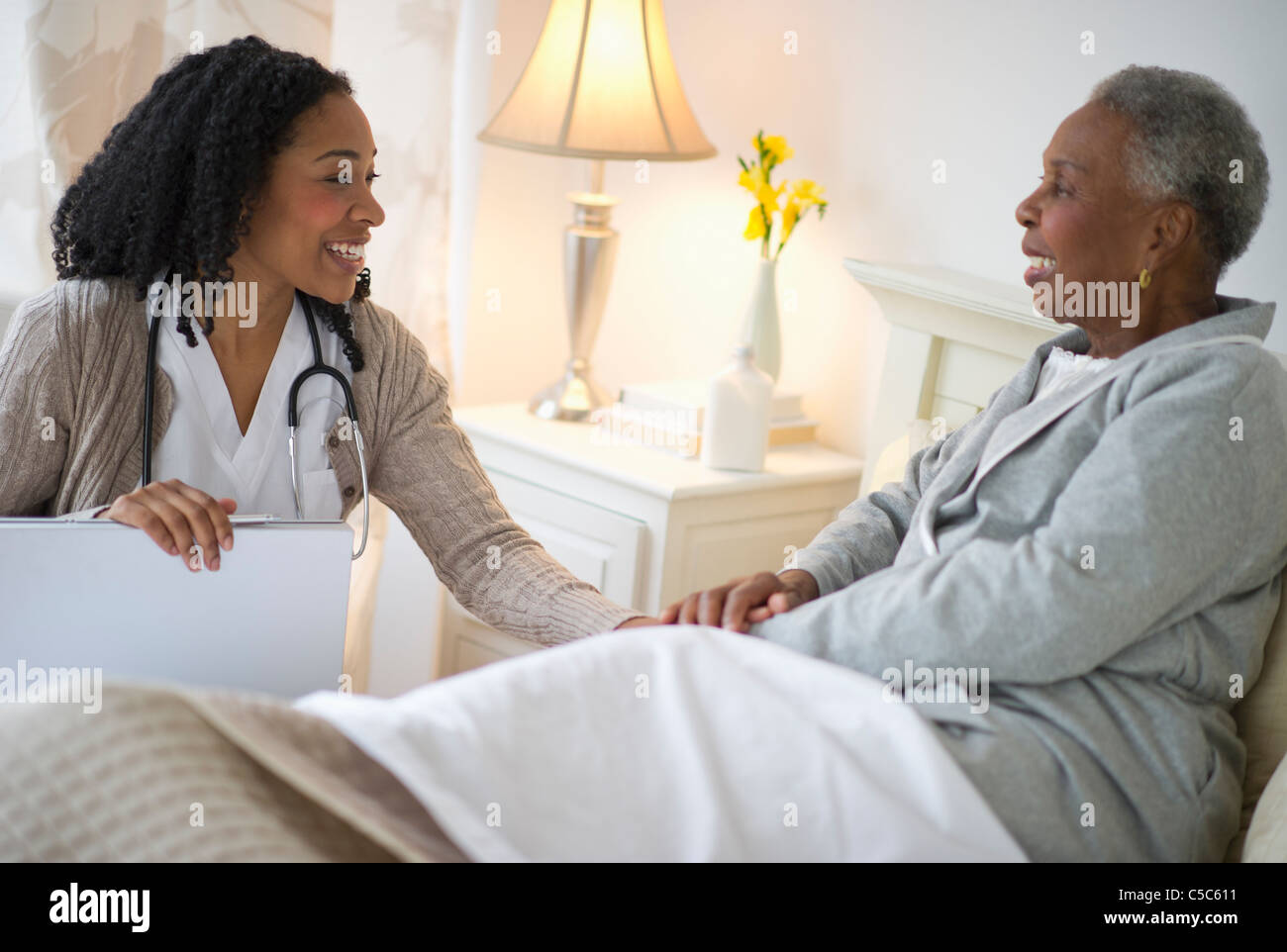 Nurse giving woman checkup Stock Photo - Alamy