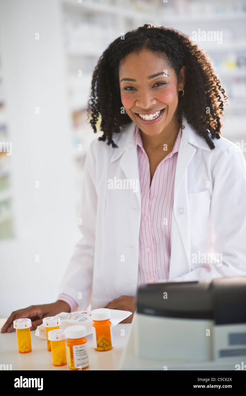 Smiling pharmacist working with medication Stock Photo - Alamy