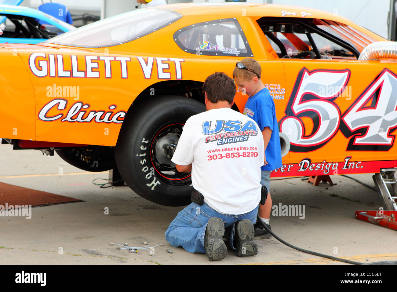 Denver, Colorado - A father teaches his son how to maintain a tire's ...