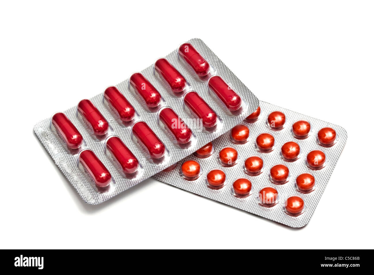 Red pills and capsules isolated on white background Stock Photo - Alamy