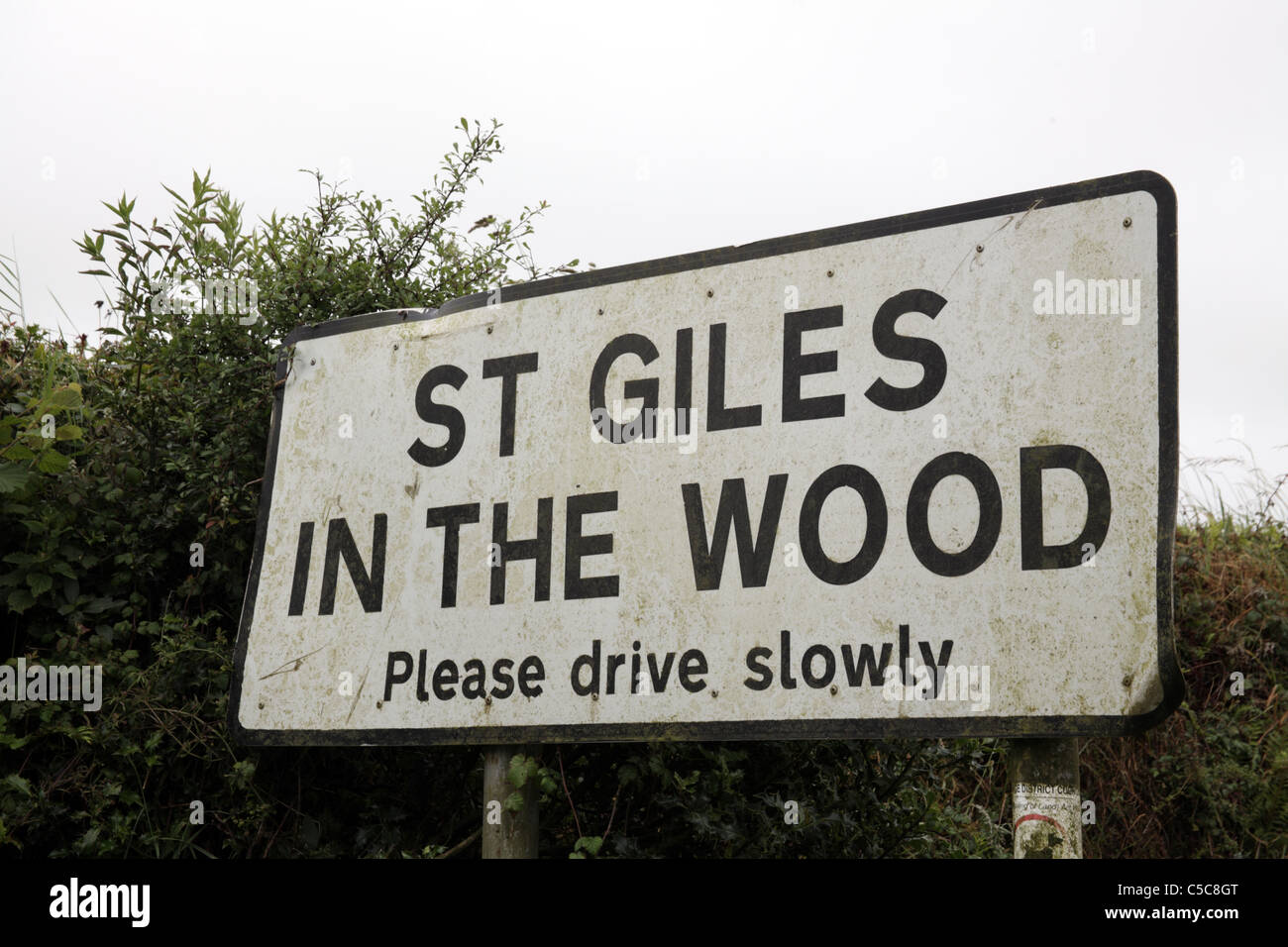 Dirty village sign entering the Devon village of St Giles in the Wood ...