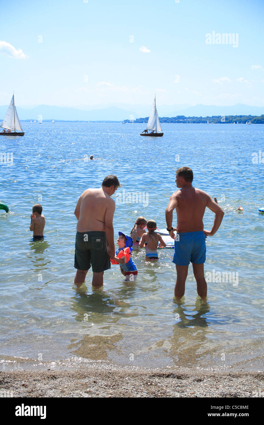 people and kids standing in water at lake starnberg city of tutzing ...