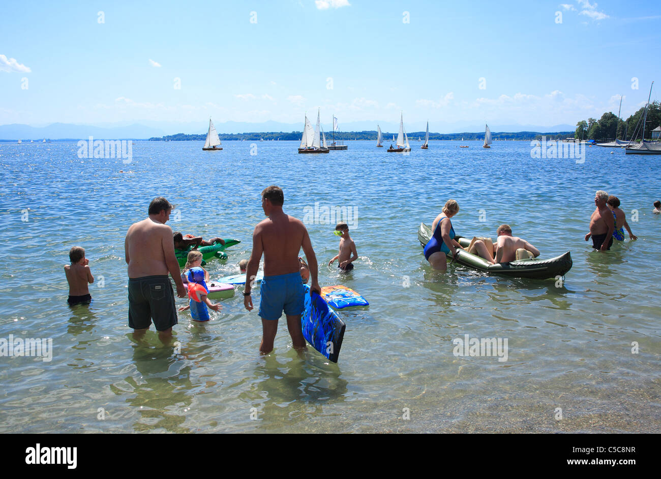 people and kids standing in water at lake starnberg city of tutzing ...
