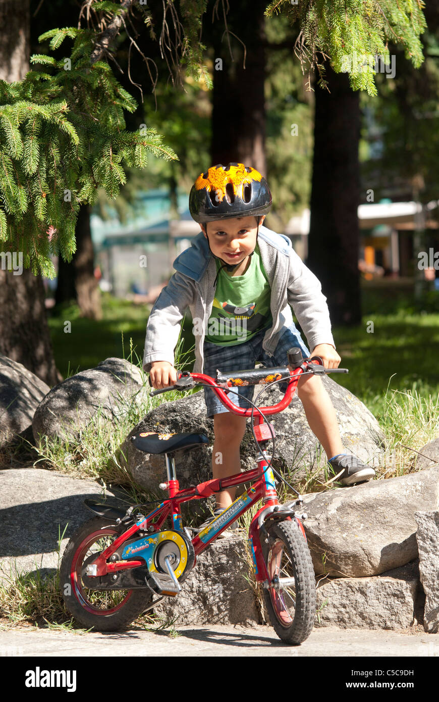 boy with bicycle wearing safety gear and helmet Stock Photo - Alamy