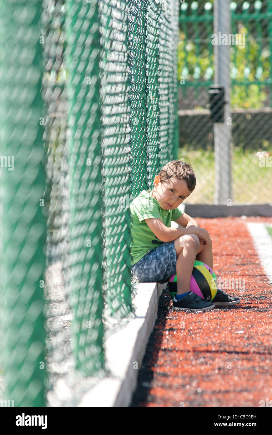 a boy having rest after football game Stock Photo - Alamy