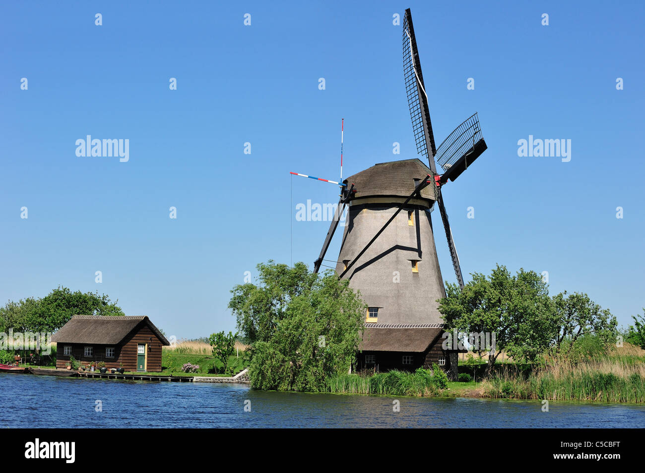 Thatched polder windmill at Kinderdijk, a UNESCO World Heritage Site at ...