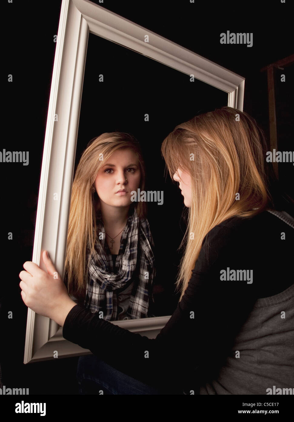 Serious woman facing mirror hi-res stock photography and images - Alamy