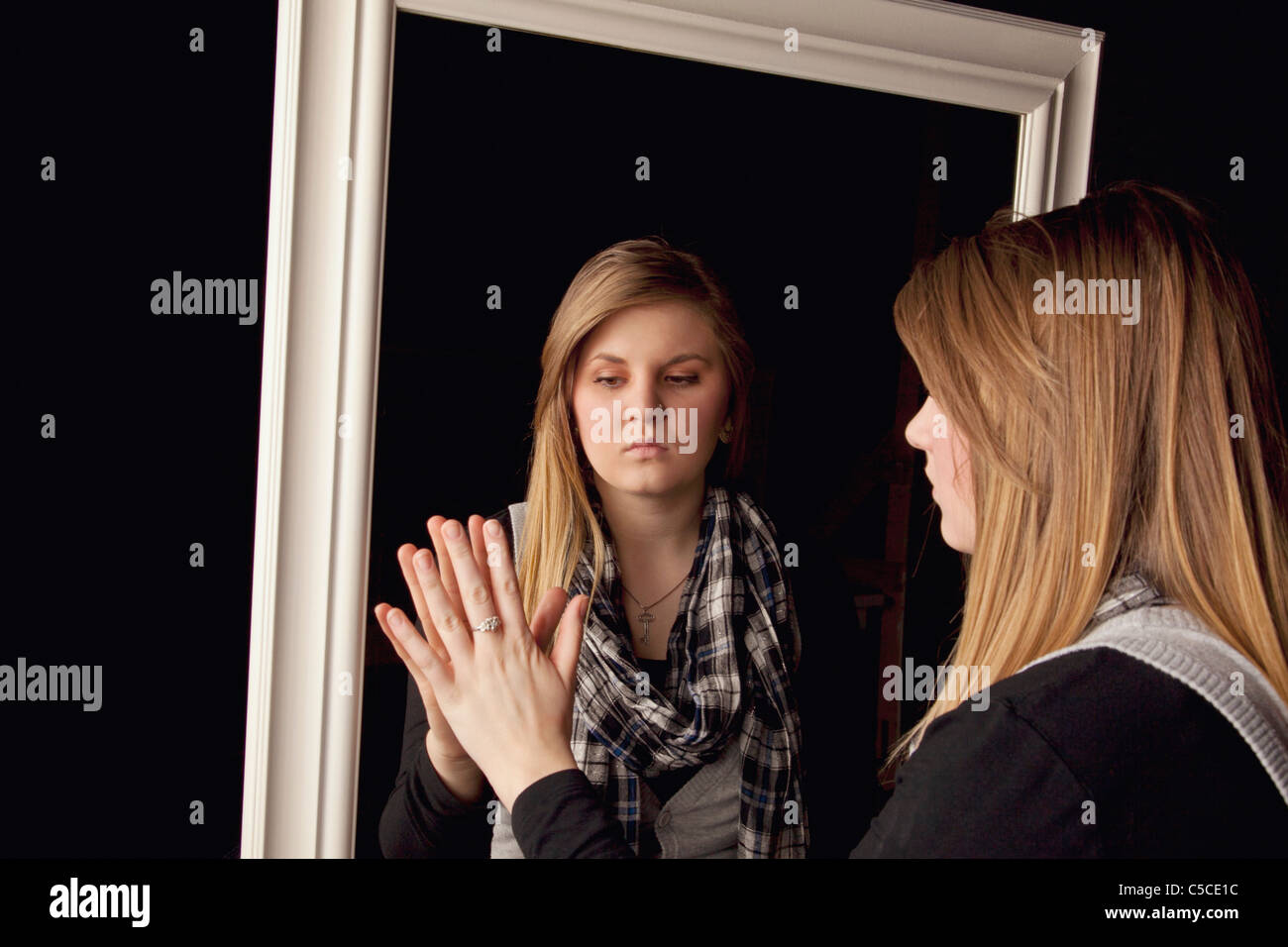 Young Woman Seeing Herself In A Mirror Stock Photo - Alamy