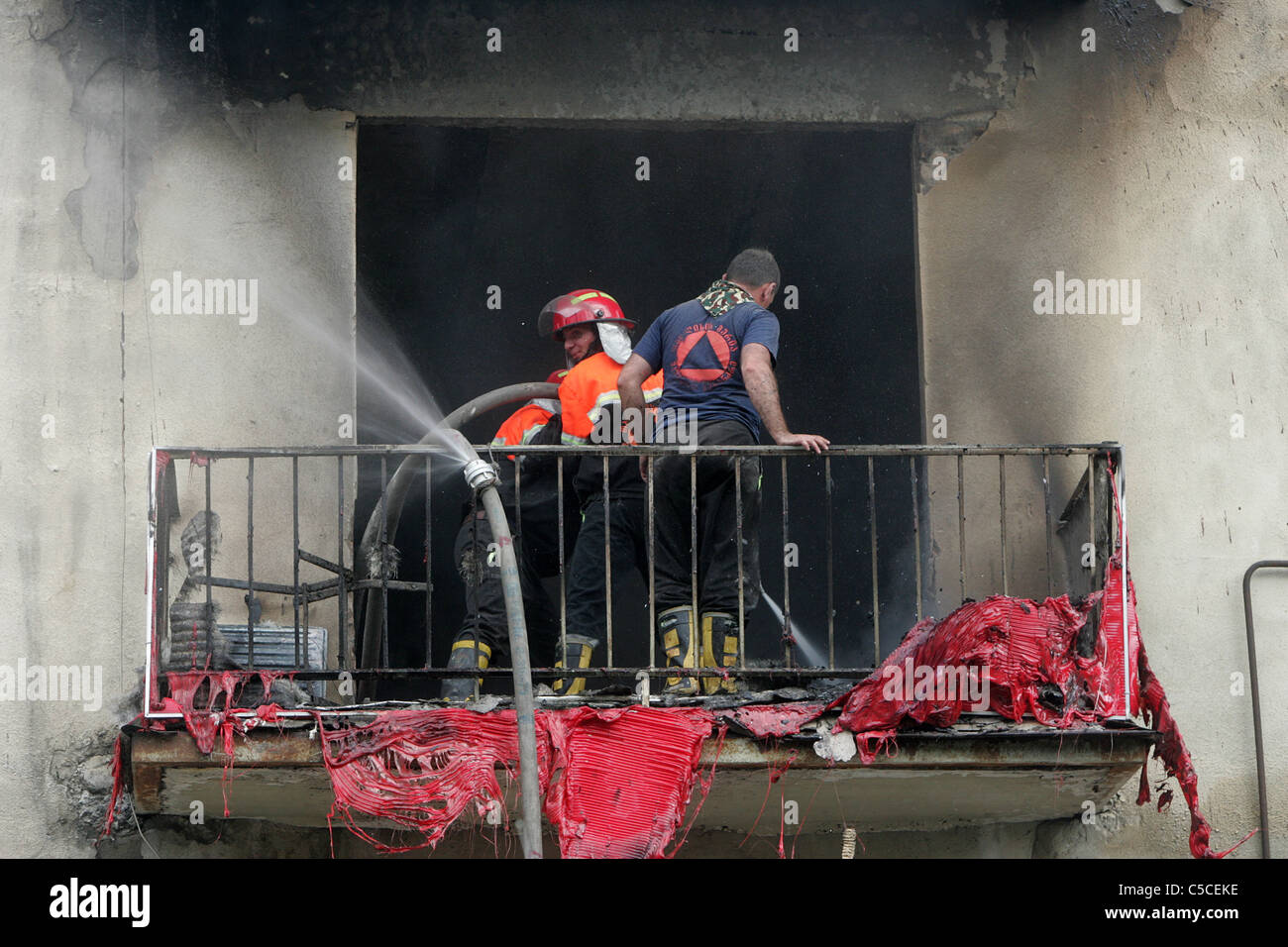 Firefighters on building balcony Stock Photo - Alamy