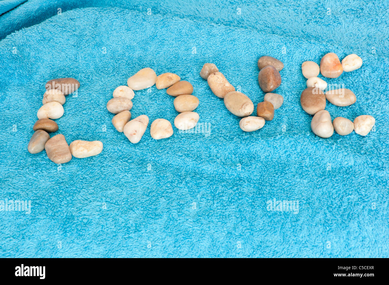 Love Sign Made of Pebbles on Blue Towel Stock Photo - Alamy