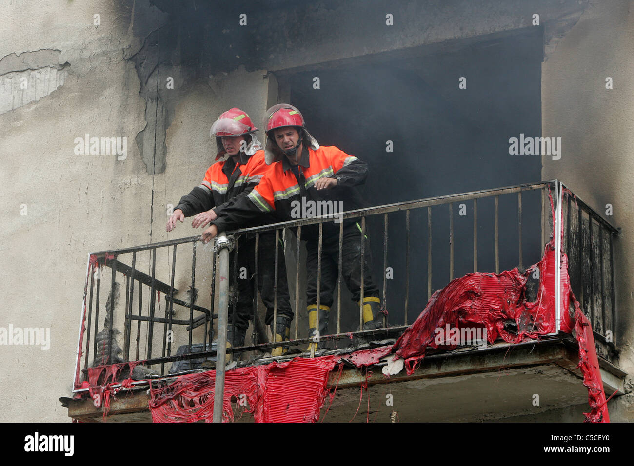 Firefighters on building balcony Stock Photo - Alamy