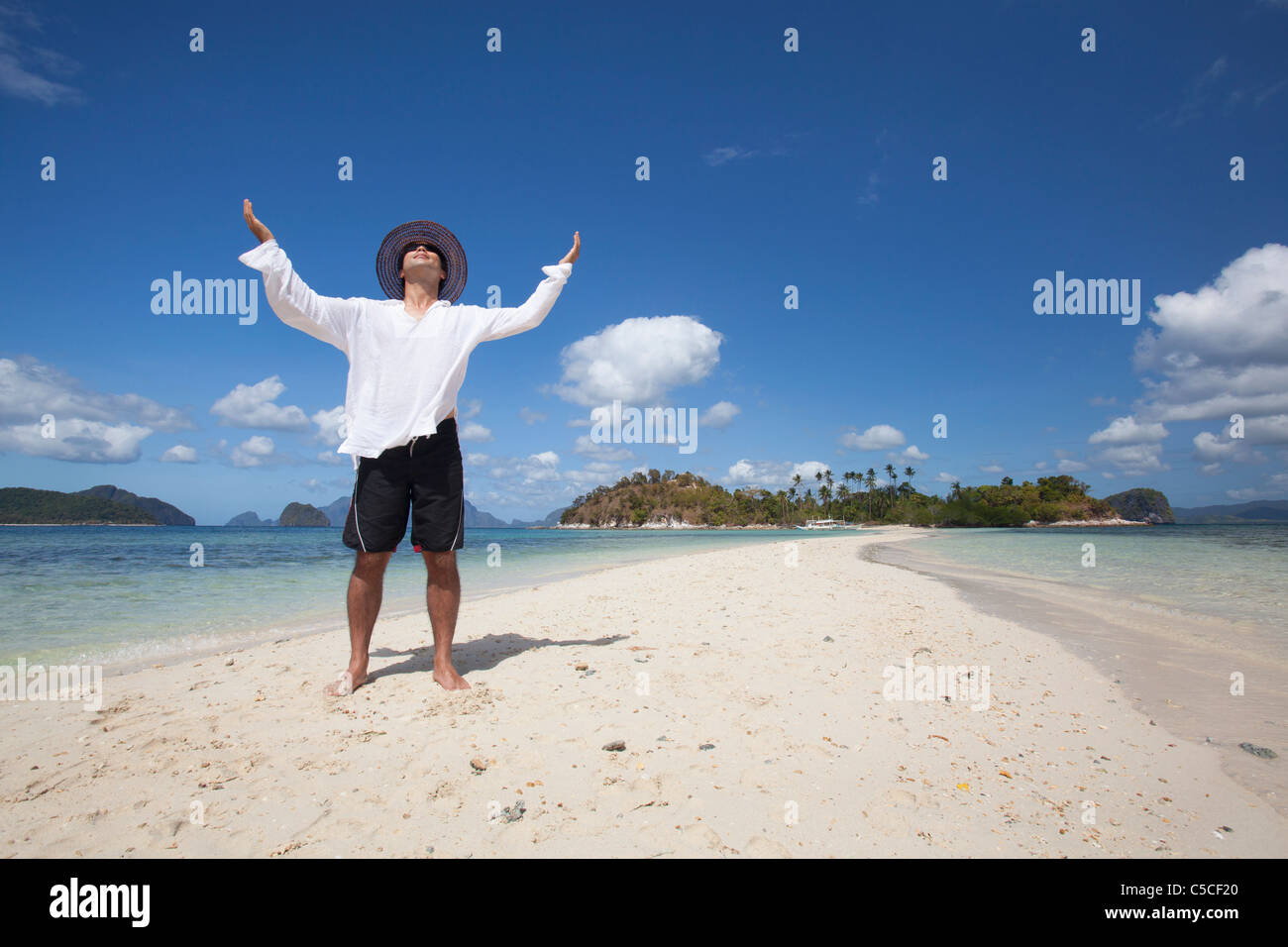 A Tourist Stands On The Pure White Sands Of Snake Island, Near El Nido ...