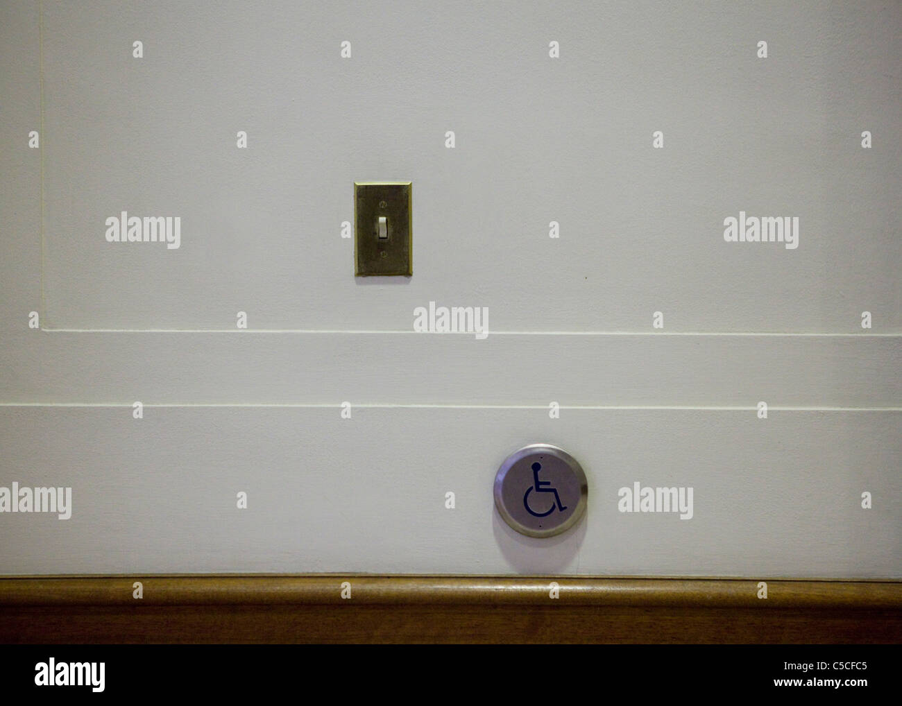 Light switch over wheelchair access door button Stock Photo - Alamy