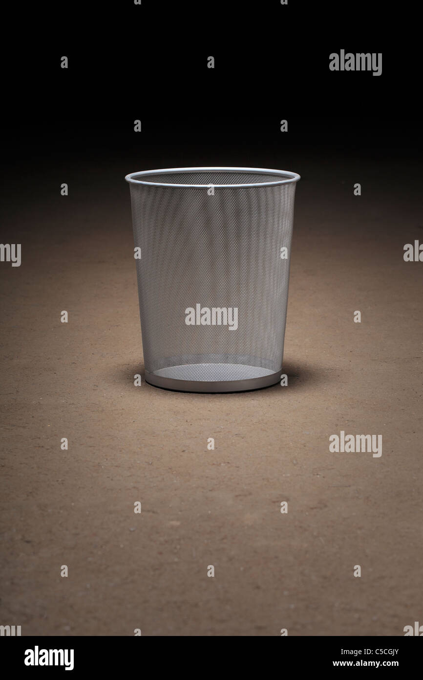 Empty wastepaper basket on dirty concrete floor Stock Photo - Alamy