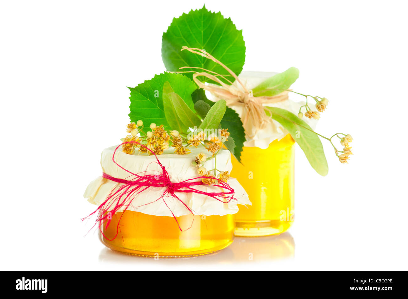 Fresh sweet honey and branch of linden tree with flowers on white ...