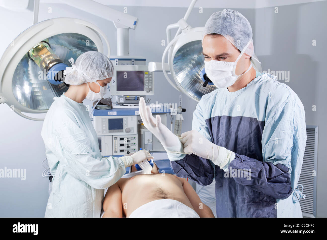 Nurse applying gas mask to the patient while doctor wearing glove Stock ...