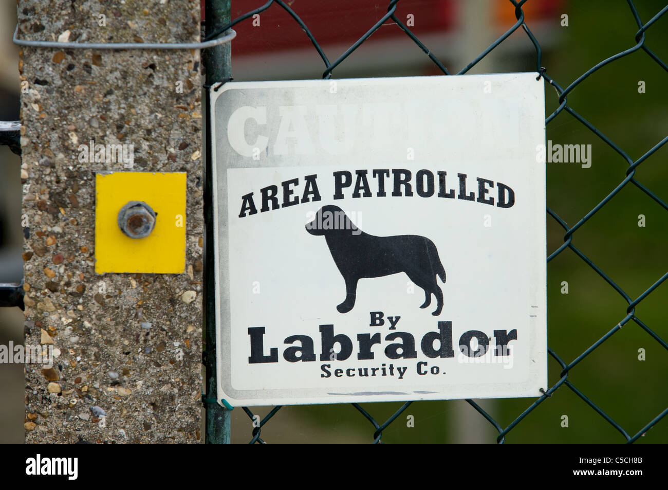Area patrolled by Labrador Security Company sign Stock Photo - Alamy
